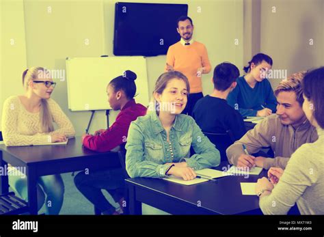Friendly Classmates Working In Groups To Complete Task During Class