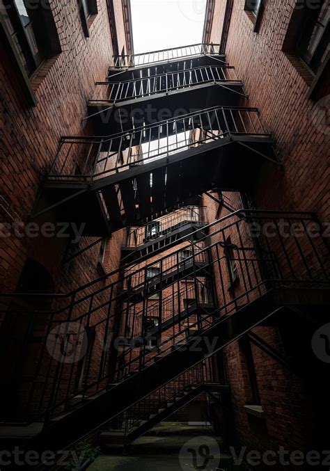 Dramatic Perspective Of A Fire Escape On A Brick Building Creating An