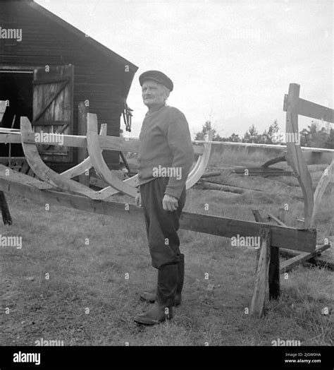 A Man Stands In Front Of A Boat That Is Being Built Probably The Man