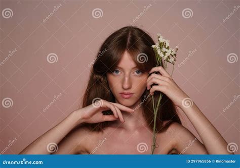Woman With Perfectly Shaped Body Sitting On Floor And Holding One Hand