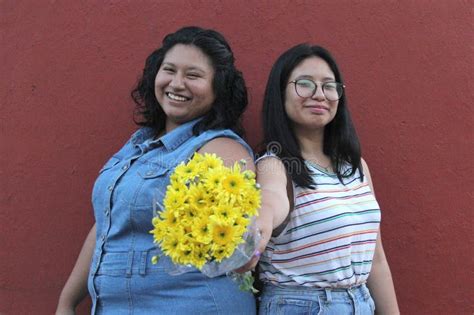 Latina Sisters And Friends Brunettes Give Each Other Yellow Flowers