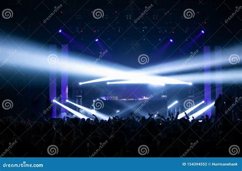 Concert Stage Lights And Crowd On Dance Floor Partying To The Music