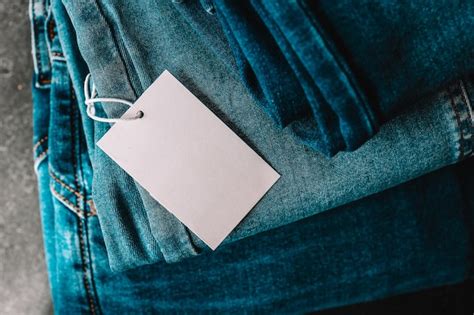 Premium Photo Tag With Space For Text And Stack Of Jeans