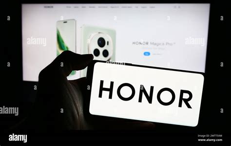Person Holding Mobile Phone With Logo Of Chinese Smartphone Company Honor Device Co Ltd In