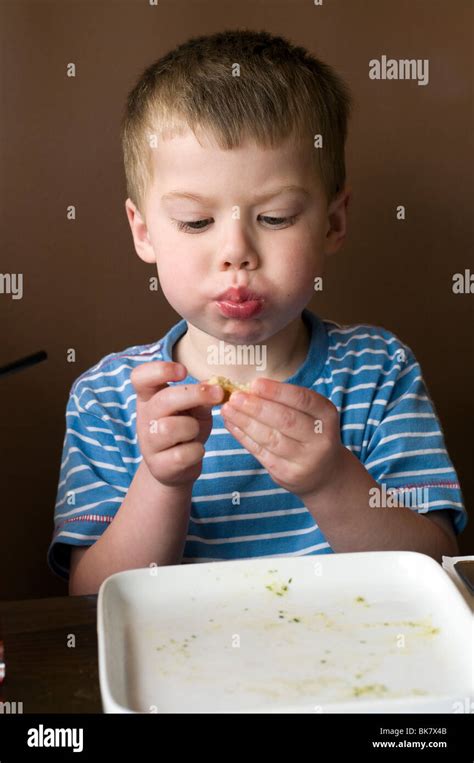 Young Boy Enjoying Garlic Bread At A Prezzo Restaurantempty Plate