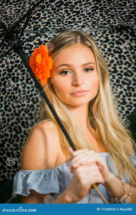 High School Senior Poses With Umbrella For Portraits On A Rainy Stock