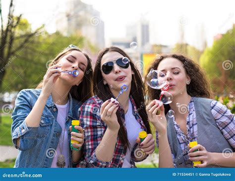 Teen Girls Blowing Soap Bubbles Young Happy Teenagers Having Fun In