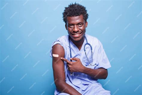 Premium Photo Male Nurse Points At Vaccine Shot Patch