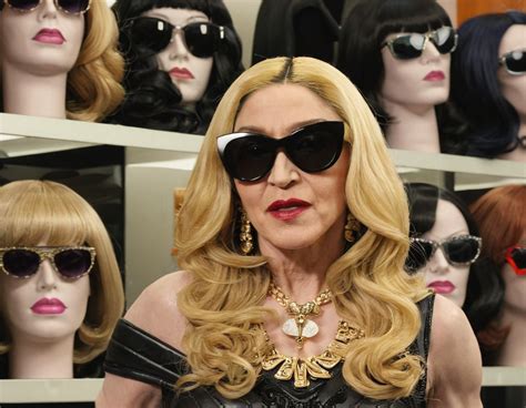 Madonna In A Black Hair Spike Hairstyle And An Elegant Suit Walking