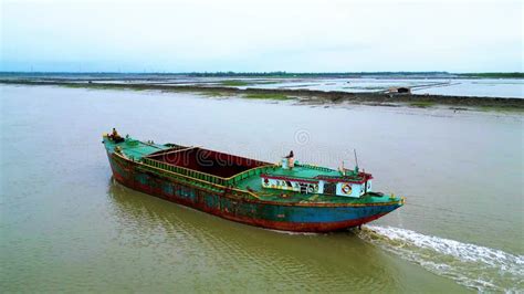 Top View Of An Empty Green Bulkhead Ship Moving Forward Through The