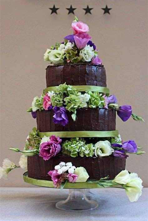 Dark Chocolate Wedding Cake With Fresh Flowers And Green Satin Ribbon