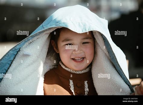 Portrait Of A Small Beautiful Cheerful And Smiling Multiracial Girl