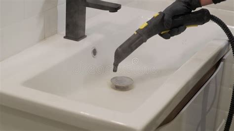 Close Up Of Steam Cleaner Sanitizing Bathroom Faucet Deep Cleaning