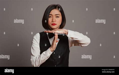 Asian Receptionist Expressing Timeout Symbol On Camera Showing Negativity And Asking For A Work