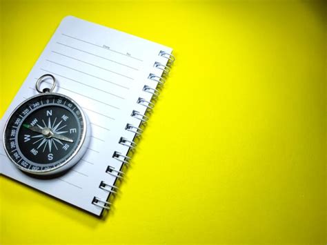 Premium Photo Selective Focus Of Compass And Notebook On Yellow