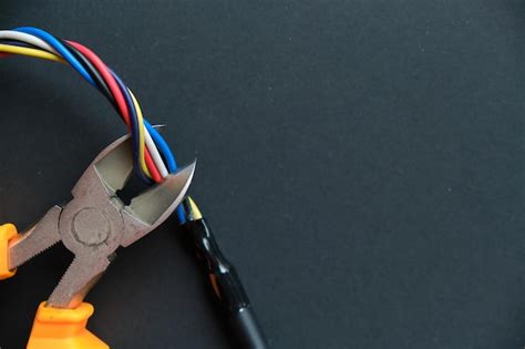 Premium Photo Electrician Cuts Electrical Wires With Pliers Cutting