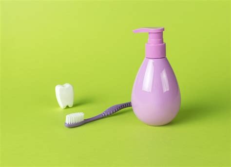 Premium Photo A Toothbrush A Tooth Figurine And A Bottle Of