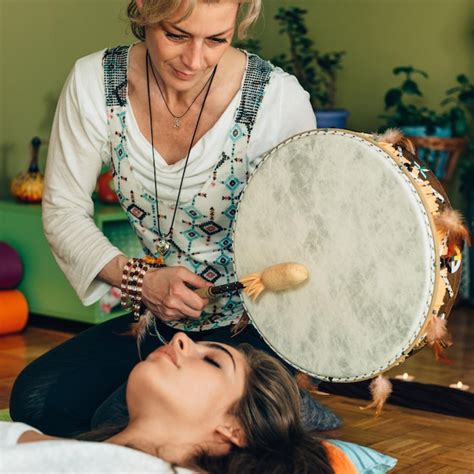 Premium Photo Therapist Playing Drum By Young Woman At Spa