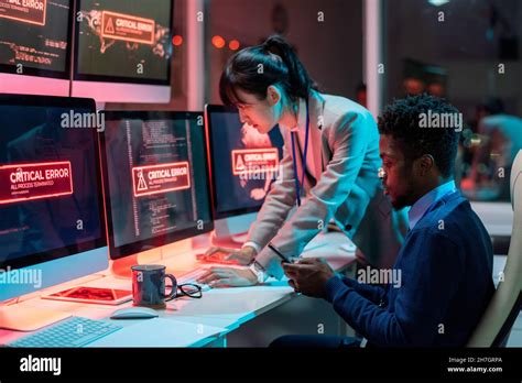 Two Young Intercultural Programmers Trying To Solve Technical Problem