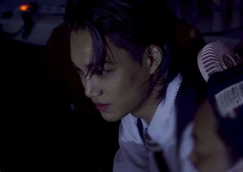 A Woman Sitting In Front Of A Laptop Computer Next To A Man With Dark Hair