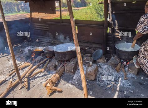Four Large Saucepans Resting On Log Fires In A Small Stall Of A Restaurant Near The City Of