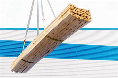 Premium Photo Wooden Boards Are Lifted Up On Lift Slings Loading