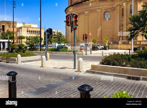 Urban Intersection With A Signal Controlled Crosswalk Stone Buildings Traffic Lights Flower