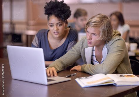 Getting Through The Work Together Two Students Researching Their