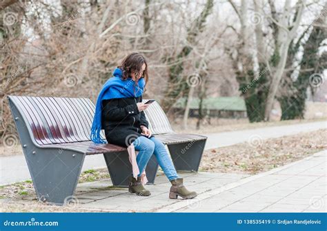 Girl Sitting Alone On Bench Reading