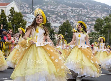 A Group Of Women In Yellow Costumes Are Dancing At Madeira Flower