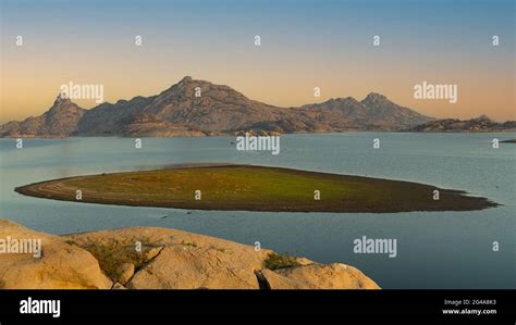 A View During An Early Morning Glow Of A Small Green Island In The