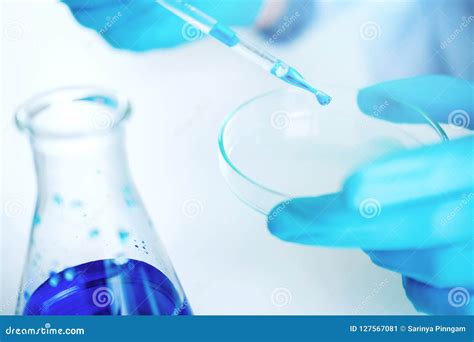 Scientist With Equipment Holding Tools During Scientific Experiment