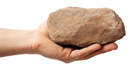 Premium Photo A Human Hand Holding A Rock Stone Isolated On White