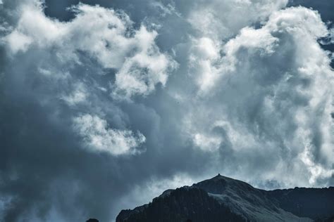 Download Magnificent Cumulonimbus Clouds Over Majestic Mountain