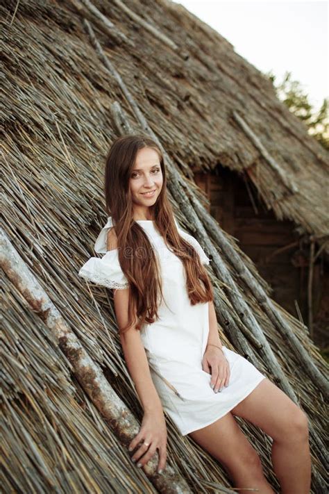 Young Woman In A White Dress At Sunset On The Nature Portrait Of A