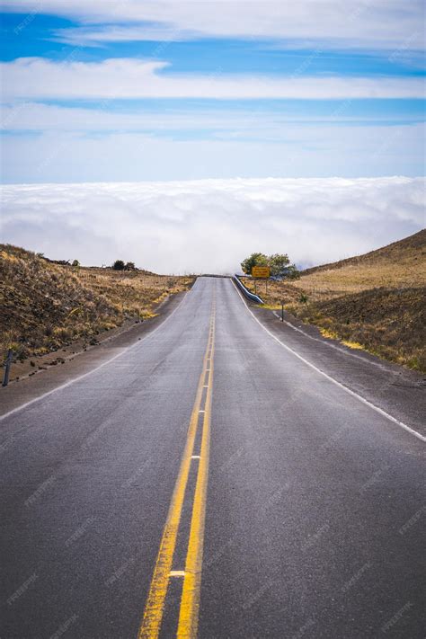 Premium Photo Vertical Shot Of A Paved Straight Road Disappearing