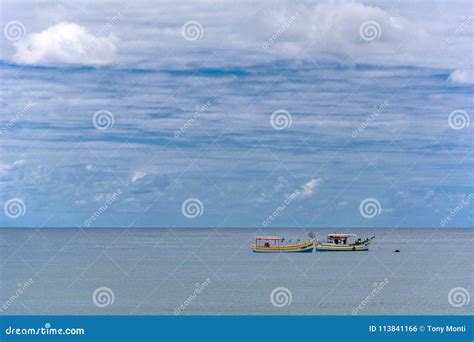 Barcos De Pesca Que Flotan En Un Mar Tranquilo Debajo De Un Cielo