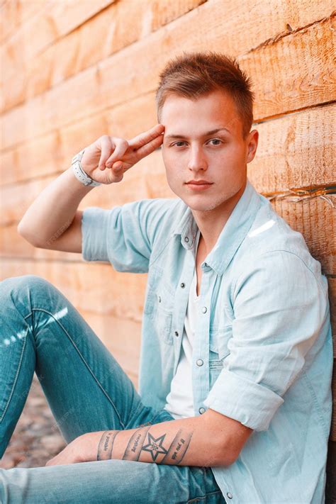 Premium Photo Cool Handsome American Man Model With A Hairstyle In Fashion Denim Clothes With