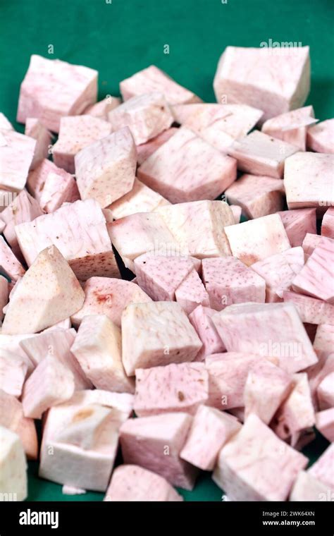 Closeup Of Taro Root Vegetable Eddo Malanga Hands Table Slice Stock