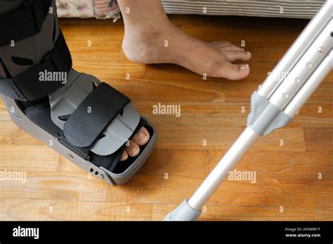Women Broken Feet With A Grey Plastic Boot Ankle Brace Injury