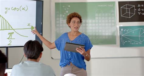 Teaching Math Woman Holding Tablet And Pointing At Whiteboard In High