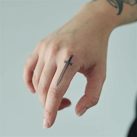 20 unique minimalist sword tattoos that are subtle sleek and stunning