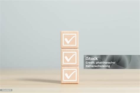wooden blocks display checkmarks to summarize task details and compile