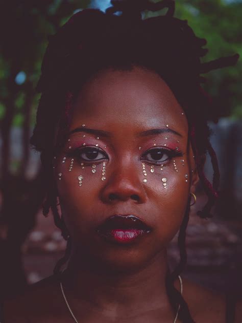 A Woman With Tears On Her Face Standing In Front Of Trees Photo Free