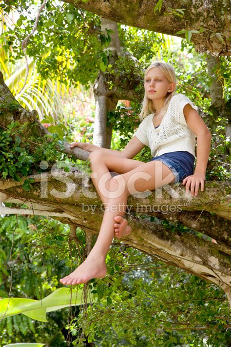 Girl Sitting Against Tree