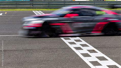 Race Car Blurred Motion Crossing The Finish Line On International
