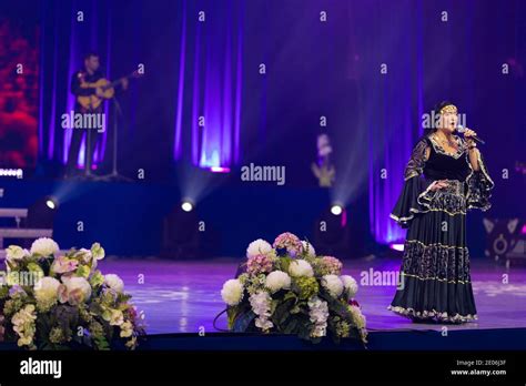 A Team Of Musicians And Singers Perform On Stage In Front Of The