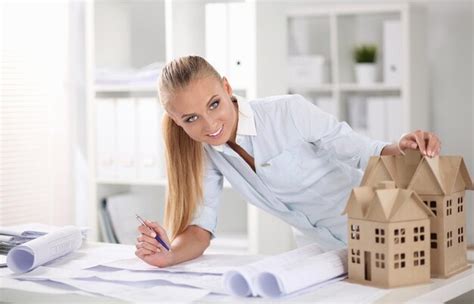 Premium Photo Portrait Of Female Architect With Blueprints At Desk In Office