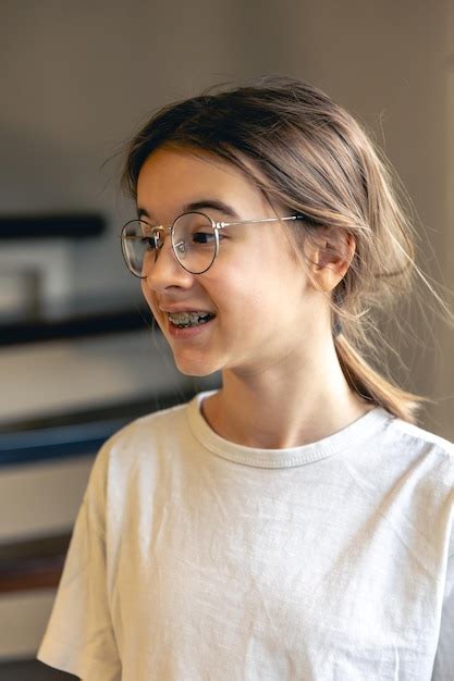Free Photo Portrait Of A Teenage Girl With Glasses And Braces