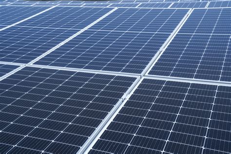 A Large Array Of Solar Panels On The Roof Of A Building Photo Free